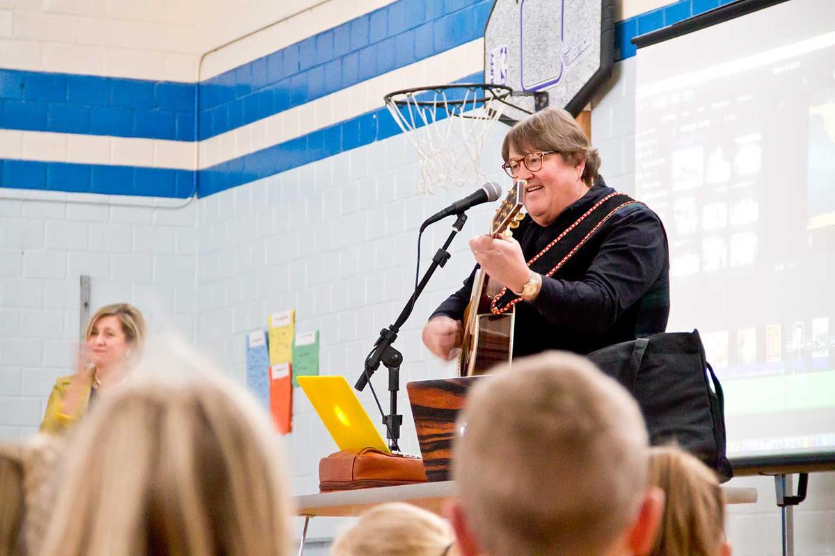 Musician Jim Salestrom strums his Buffalo Bill songs at Park Elementary