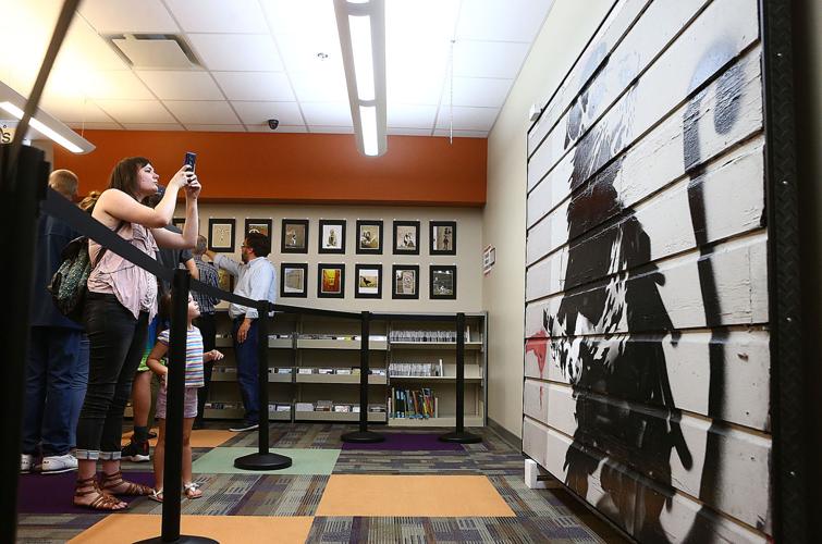 Visitors Respond As Banksy Artwork Unveiled At Kokomo Library Local
