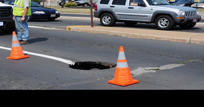 Manhole collapse closes road into downtown