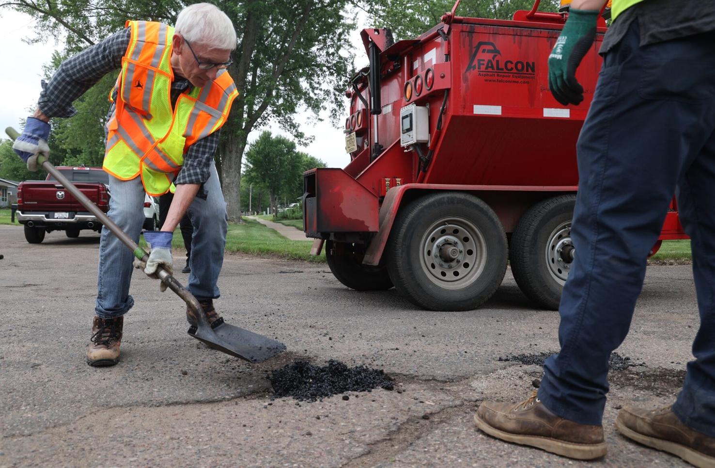 Gov. Evers helps fill potholes in Altoona | News | leadertelegram.com