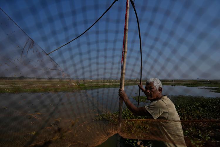 Photos of a community catch in an Indian fishing village marking the ...