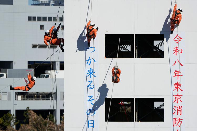 Photos show daring ladder stunts performed by Tokyo's rescue team at ...