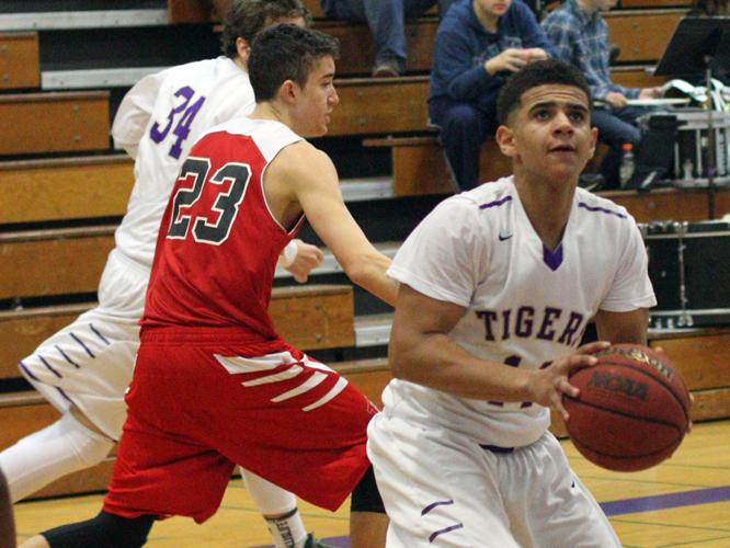 Boys basketball: Tigers erase late 10-point deficit in win over Trojans ...