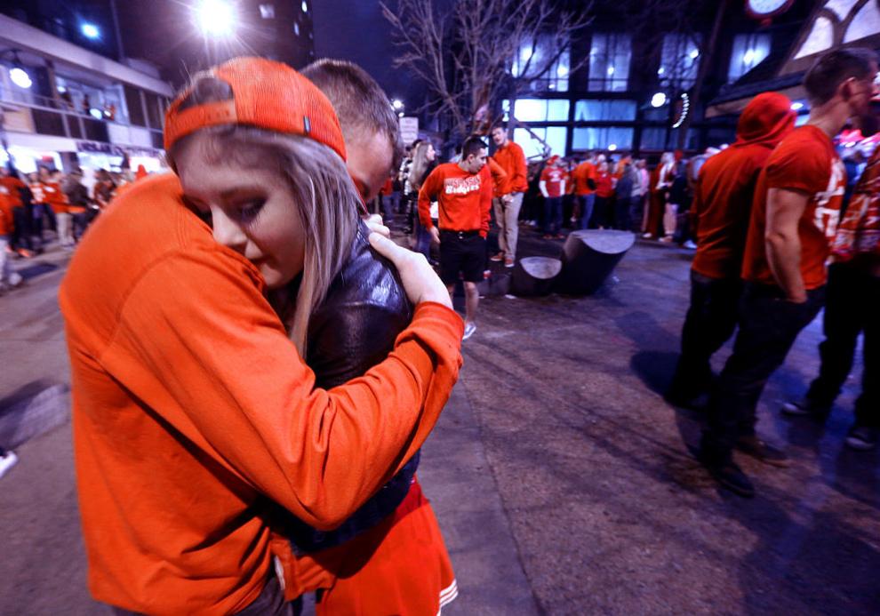 Sad Badgers fans hug after loss to Duke, State Journal photo