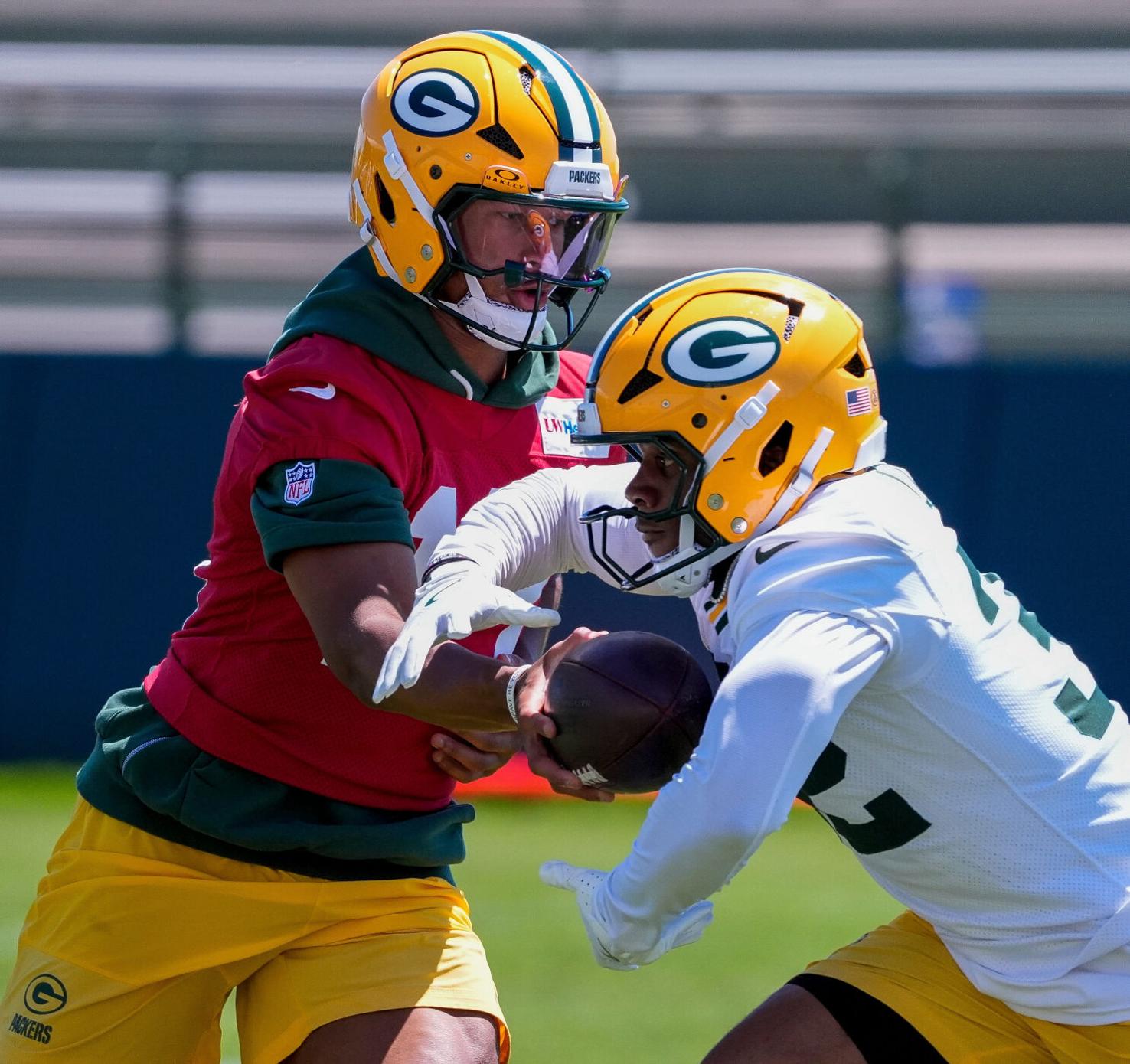 Green Bay Packers quarterback Kyron Drones (13) hands the ball to ...