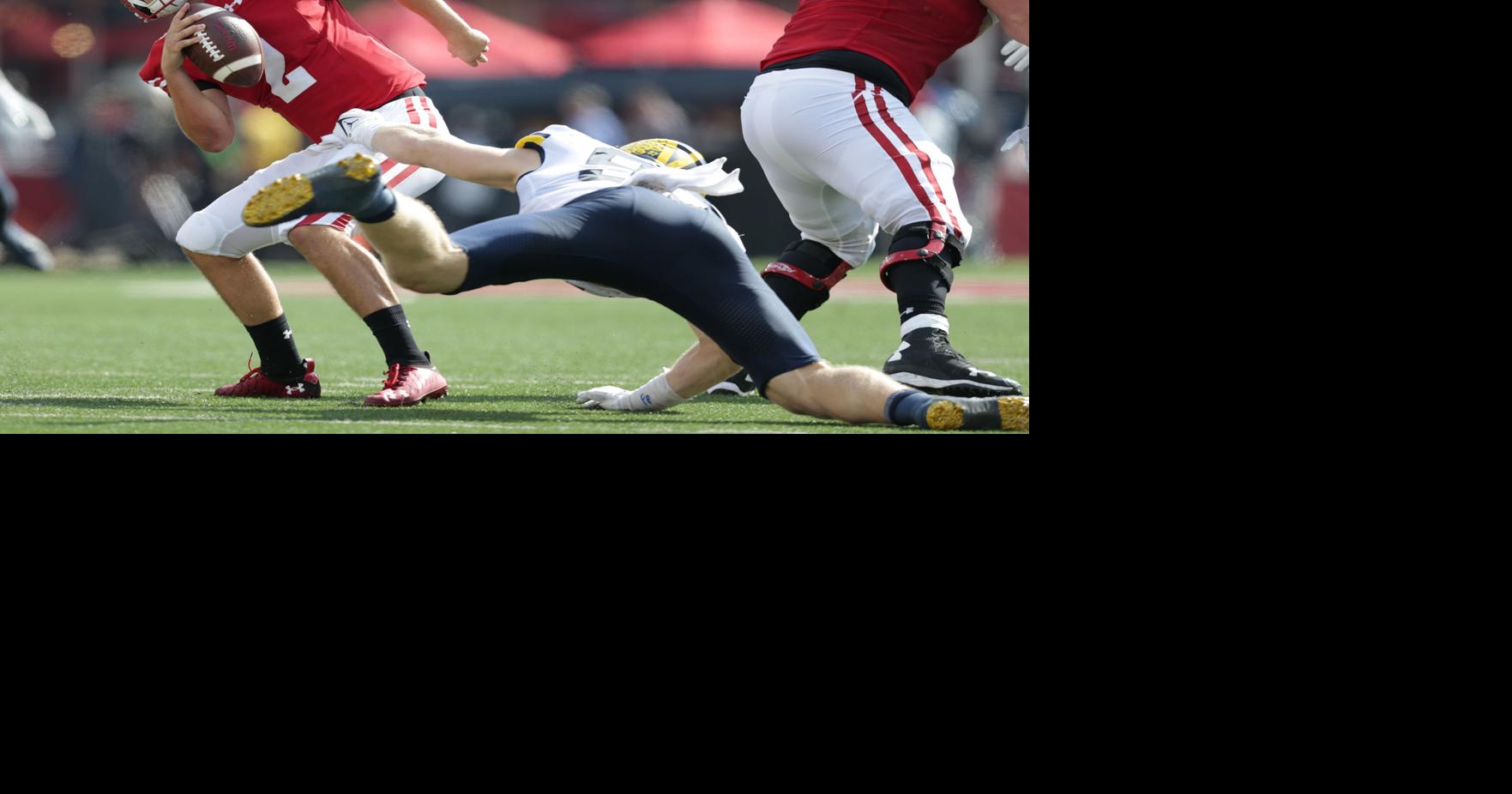 Wisconsin offensive line slows down Michigan's Aidan Hutchinson, but ...