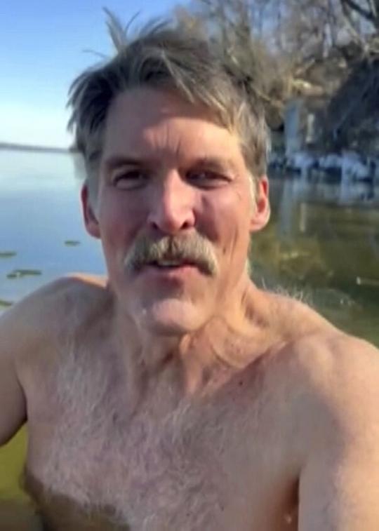 Eric Hovde jumps in a lake to show he's a tough Wisconsinite