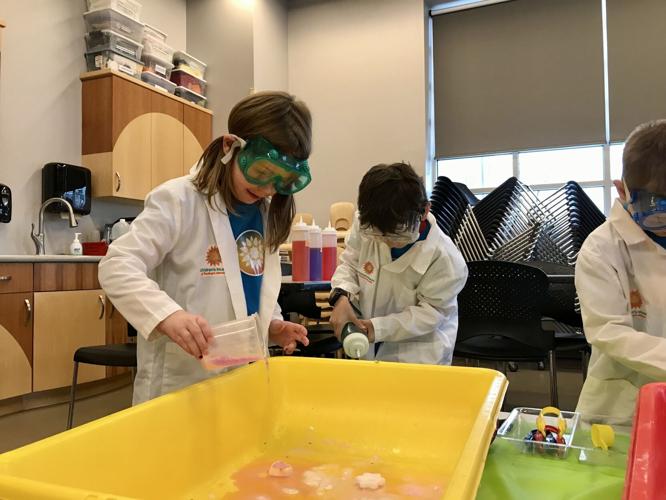 Students get their hands messy with experiments at first Early Out Camp ...