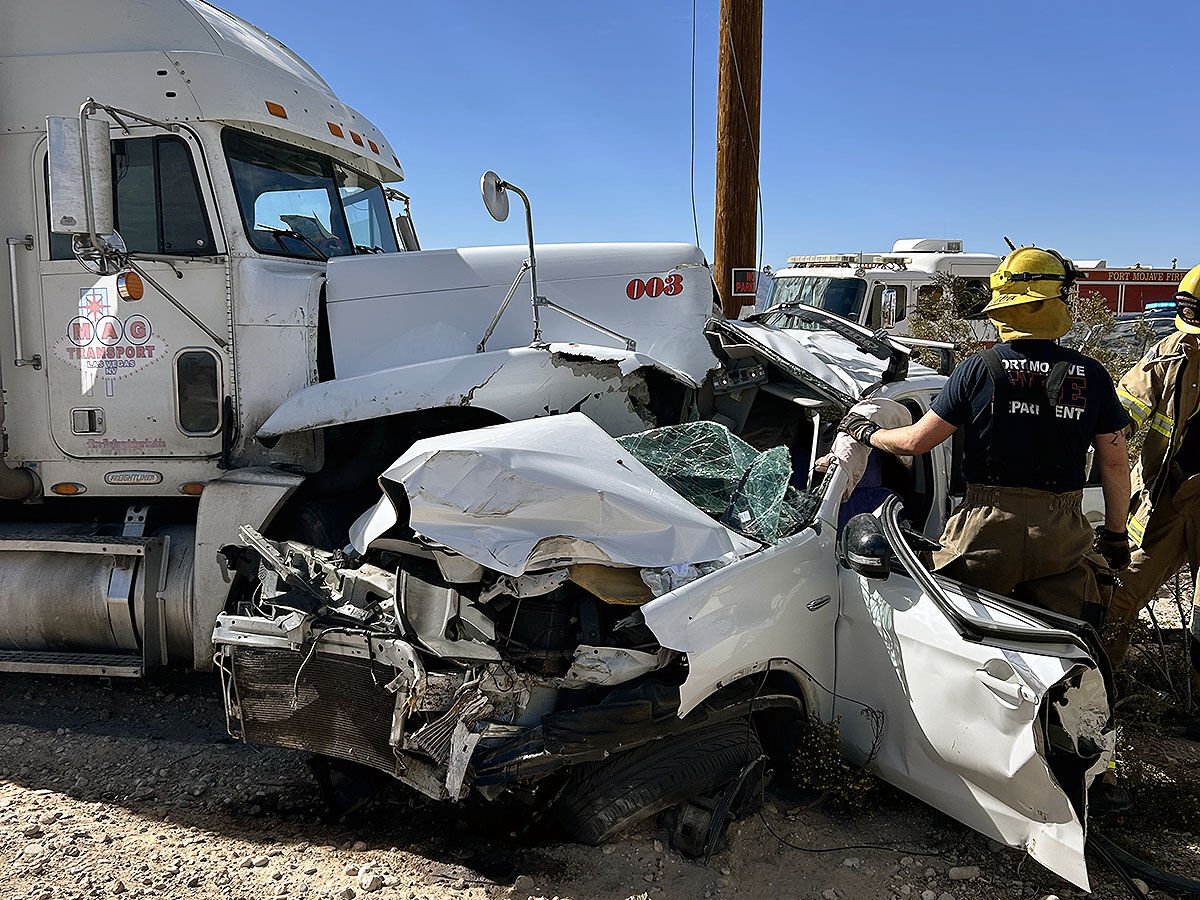 Driver hospitalized after being extricated from her vehicle following crash with a semi truck in ...