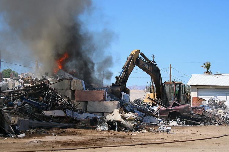 Punctured refrigerant compartment sets metal scrap pile on fire in ...