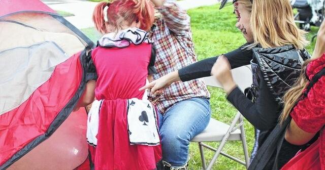 Trick-or-treaters abound in Dobson Square Park during Halloween ...