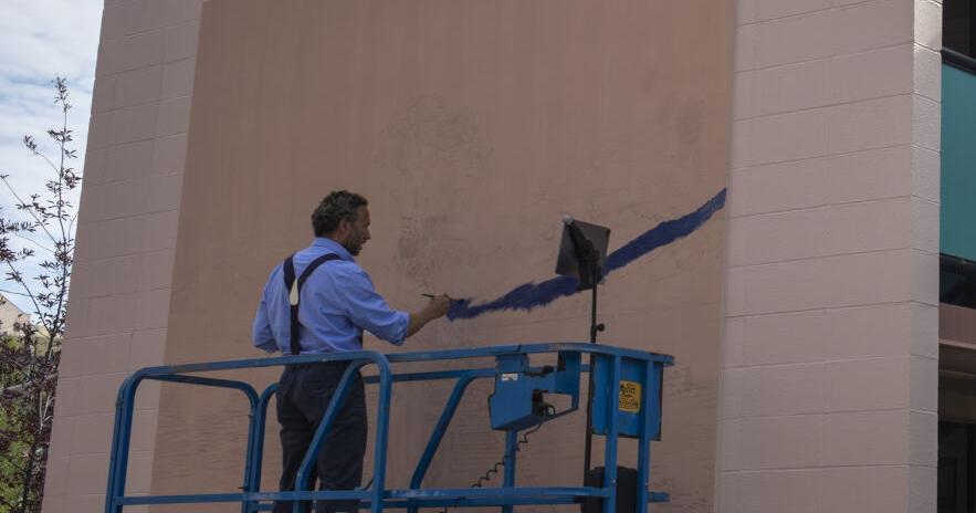 Renowned artist painting mural in Butte
