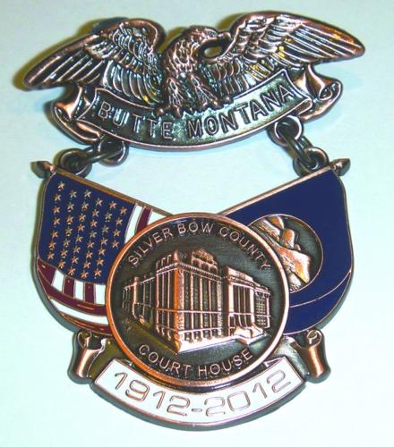 Courthouse Centennial lapel pins available at Archives