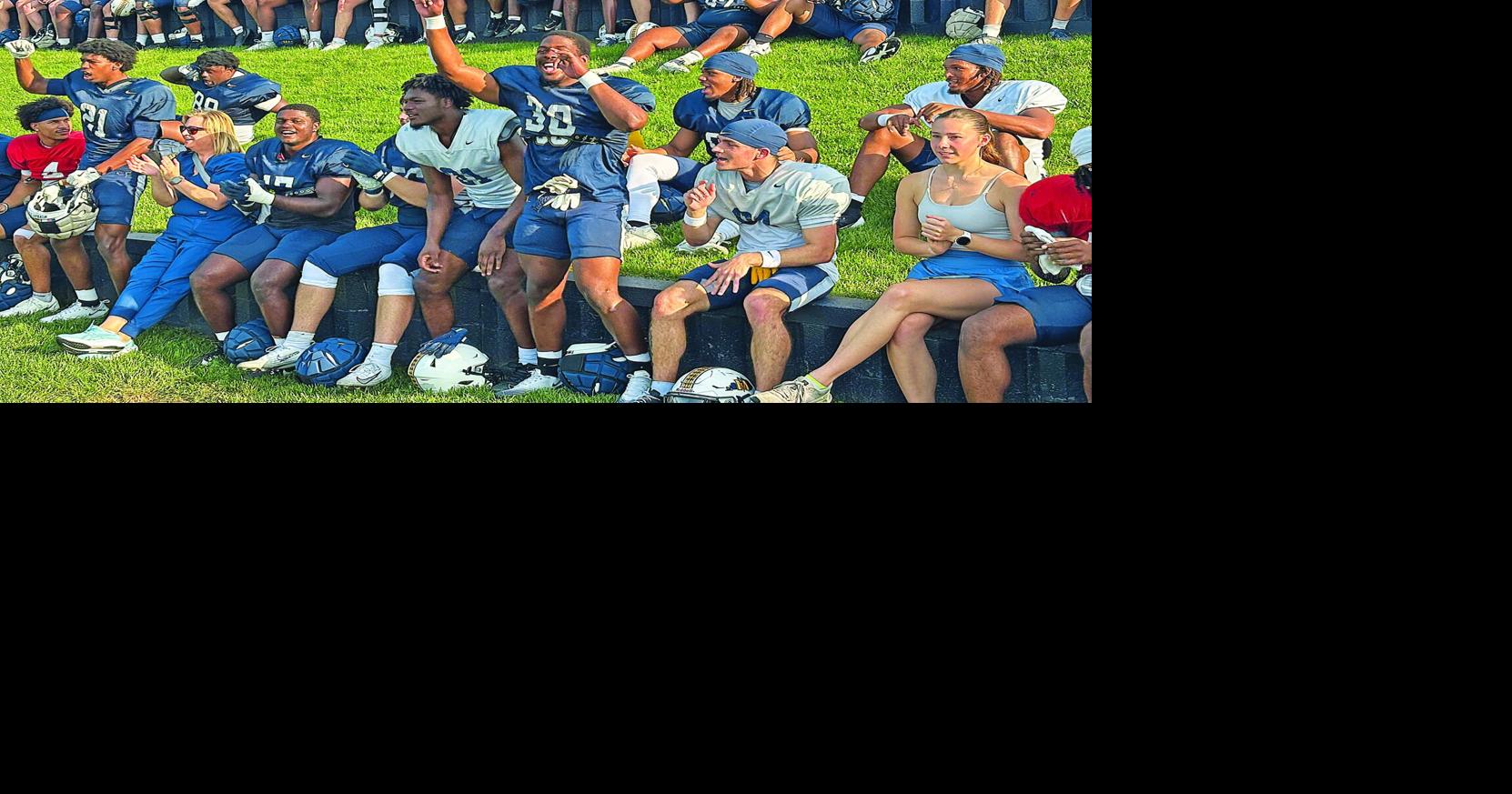 Showing their Racer spirit; Football team’s visit to baseball game ...