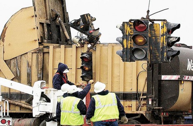 Traffic signal trashed; garbage truck mishap damages lights, pole