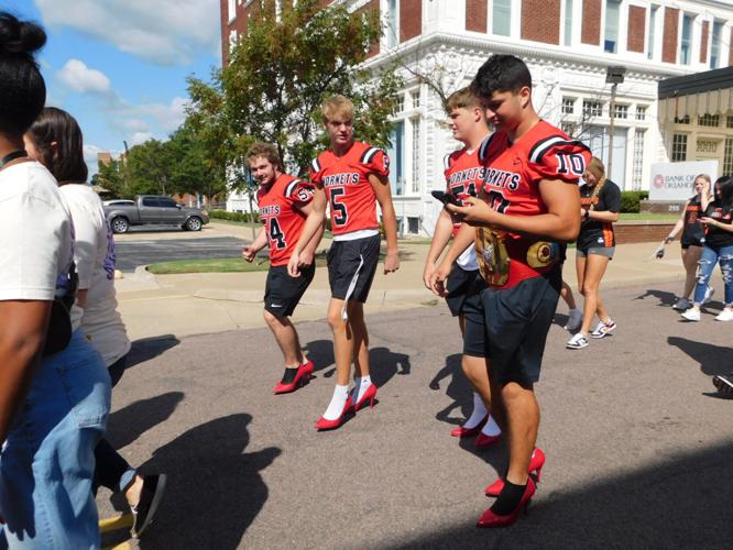 Athletes, co-workers and others Walk in Her Shoes for domestic violence ...