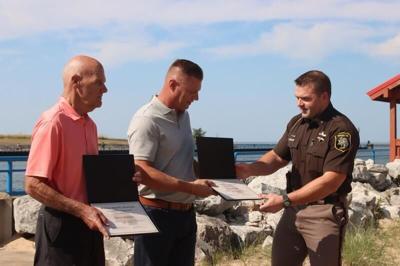 Two MI boaters recognized by Coast Guard after saving family in ...