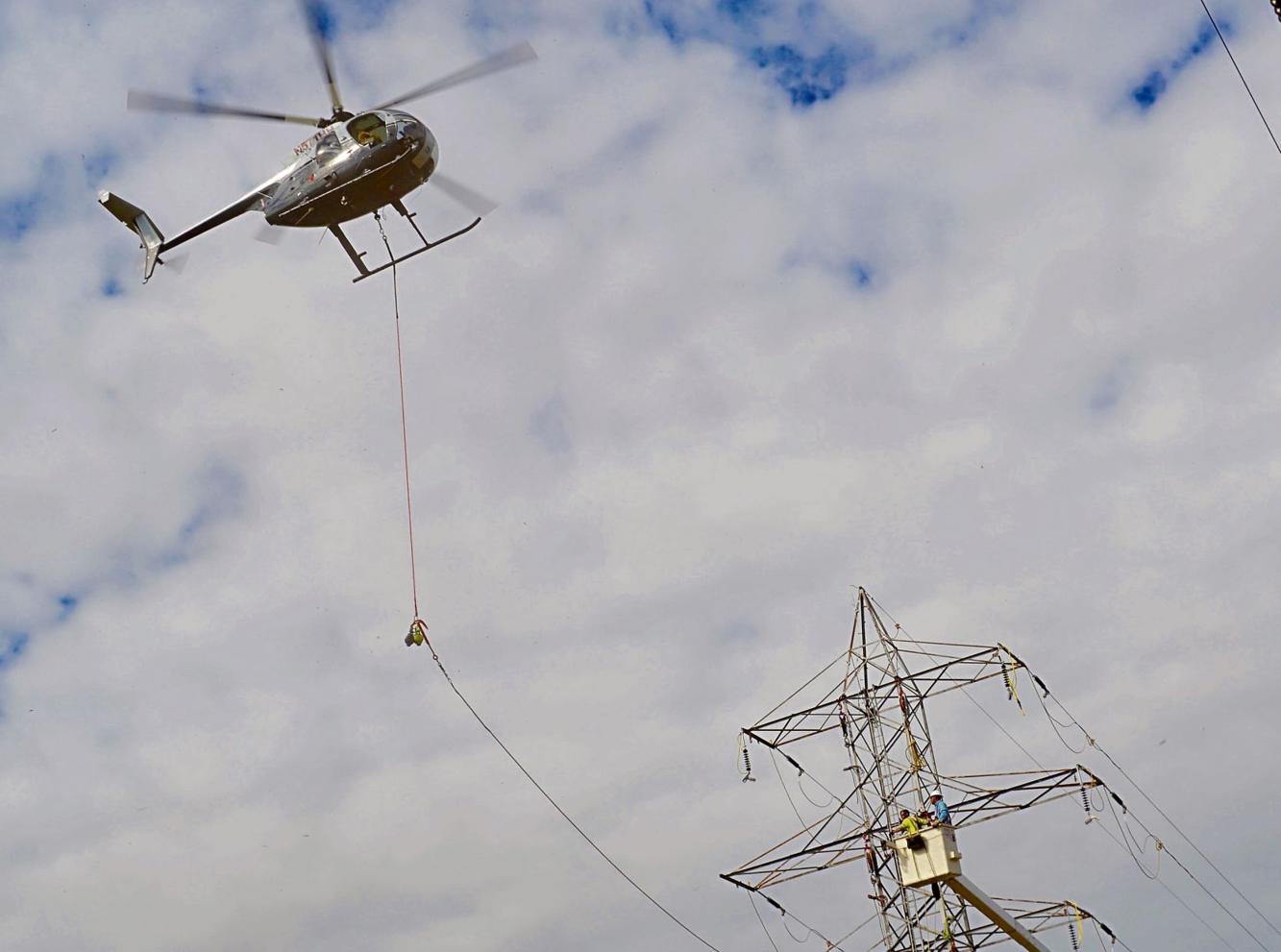 WATCH VIDEO: Linemen dangling from helicopters bring electric upgrade ...