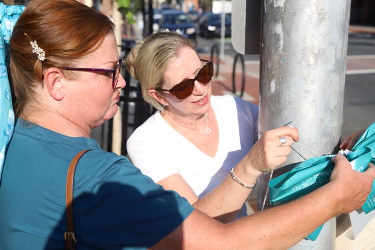 Volunteers 'turn the town teal' for ovarian cancer awareness | News ...