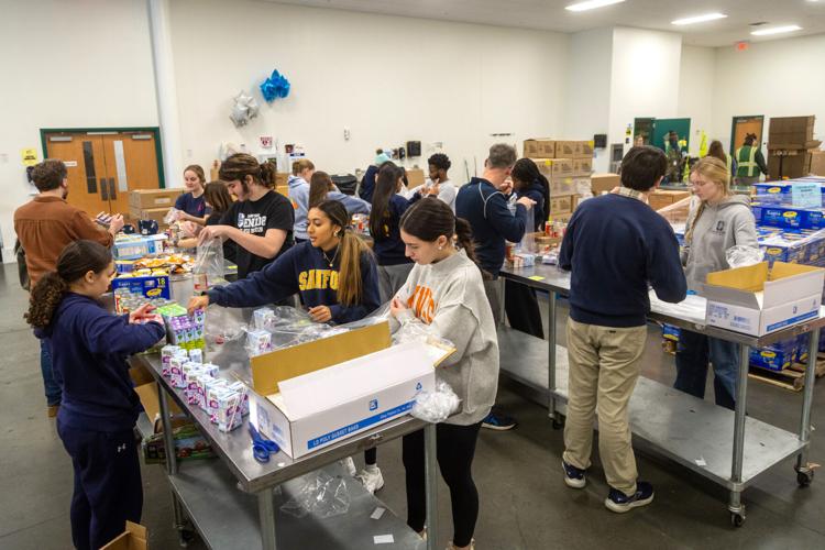 'Spirit of community': Food Bank volunteers pack meal kits during MLK ...