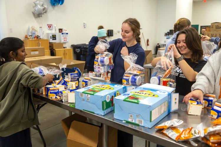 'Spirit of community': Food Bank volunteers pack meal kits during MLK ...