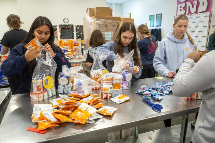 'Spirit of community': Food Bank volunteers pack meal kits during MLK ...