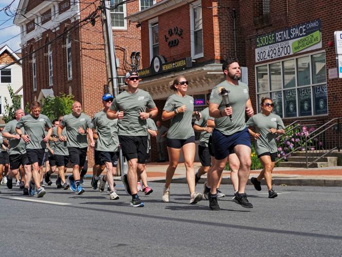 Police officers carry Special Olympics torch down Main Street | News ...