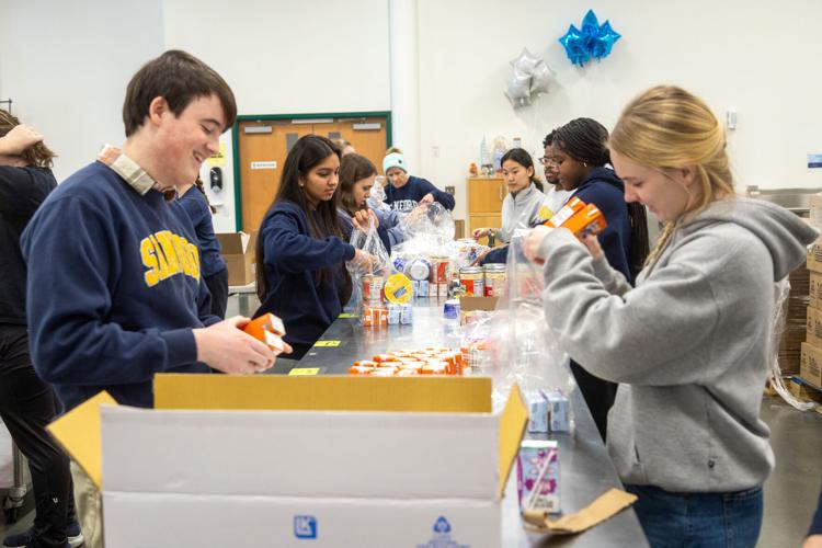 'Spirit of community': Food Bank volunteers pack meal kits during MLK ...