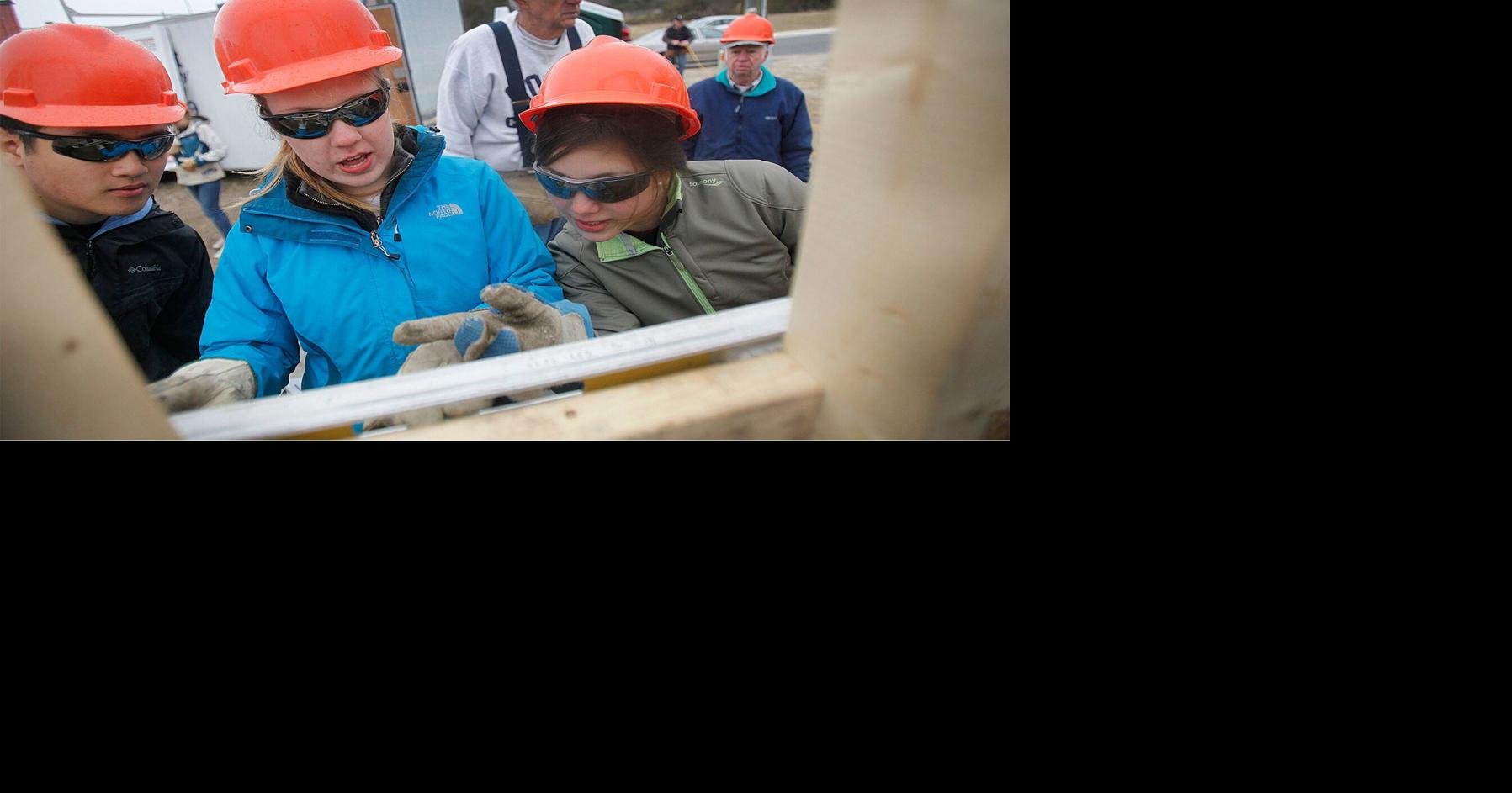 University students spend break time helping others at Habitat build ...