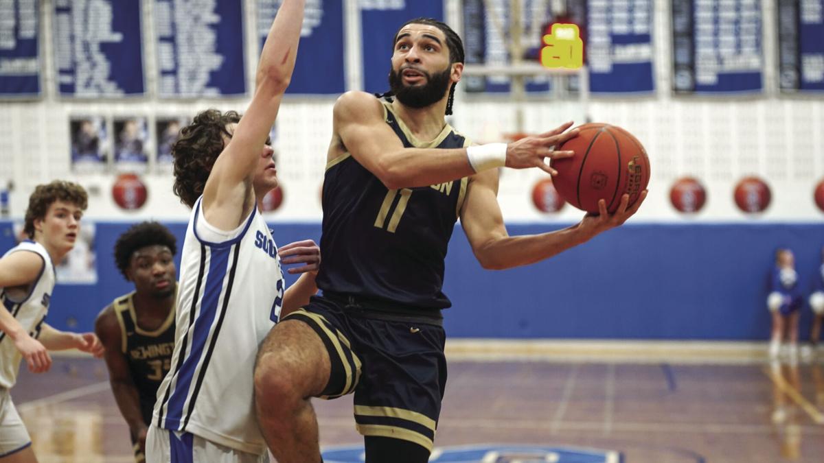 Newington senior Adam Alexander drives to the hoop for a layup against ...