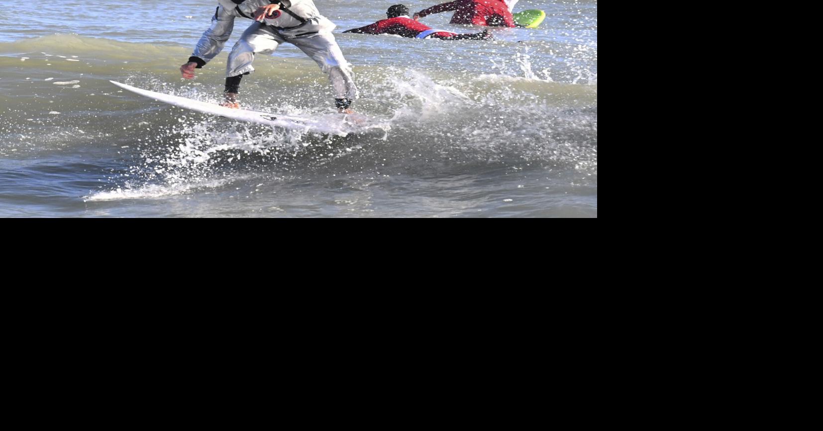 Frigid weather doesn't stop Santas surfing off Florida coast