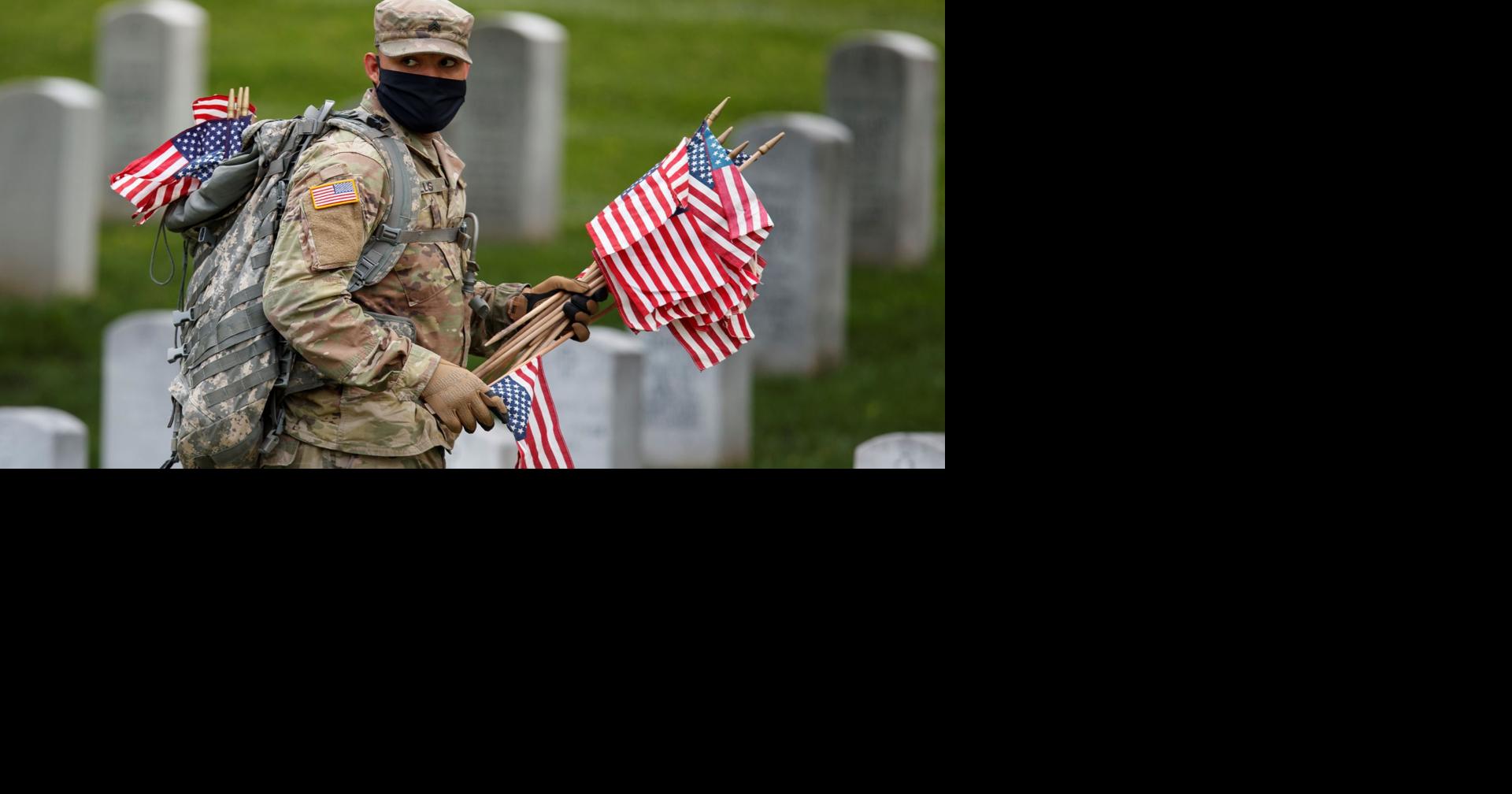 Photos: Flags placed in front of headstones at Arlington National Cemetery
