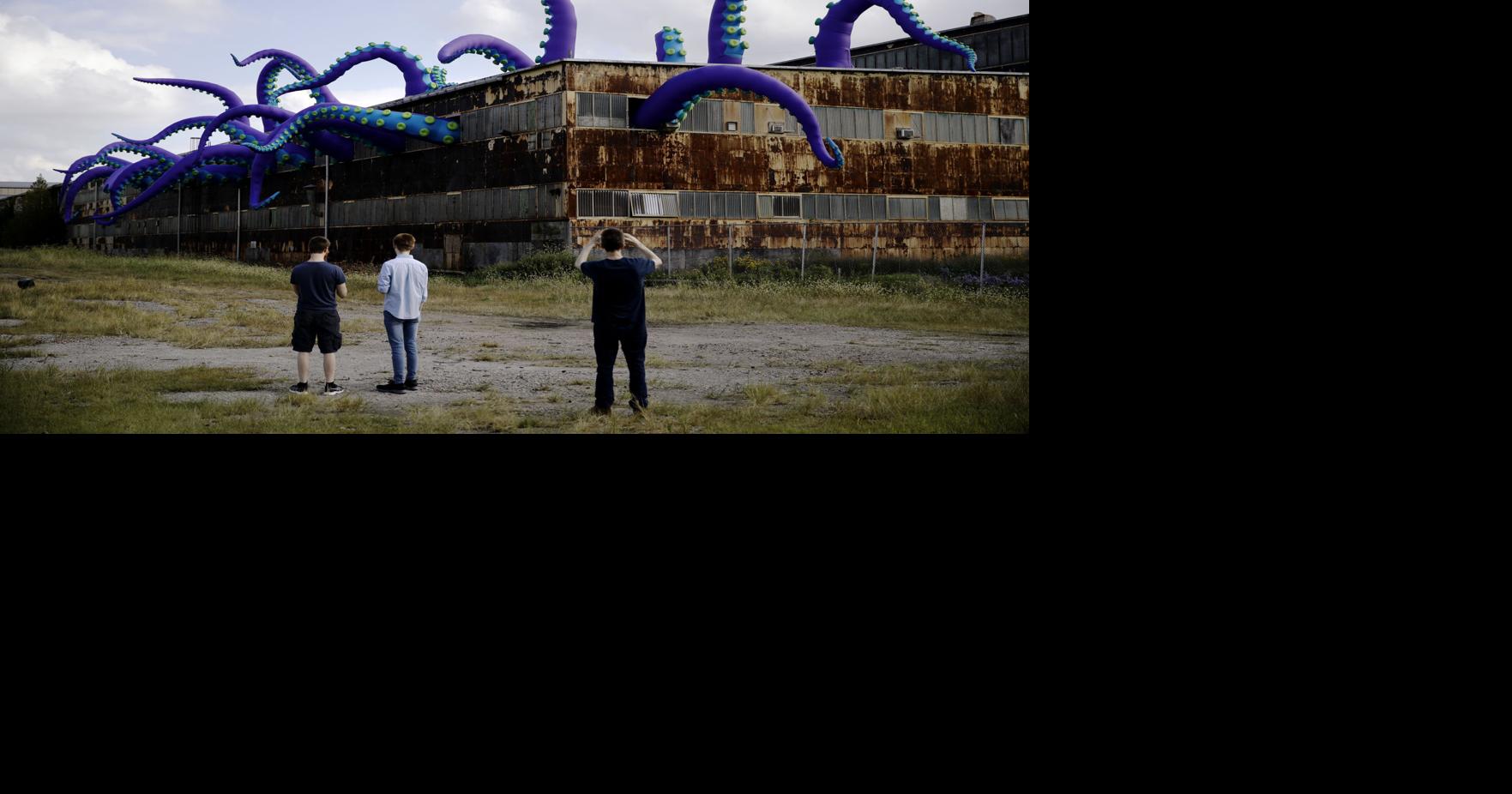 Inflatable sea monster takes over a rusting warehouse