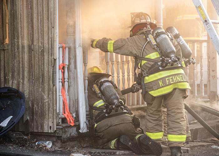 Firefighter rescued from ridge of roof during Springfield house fire ...