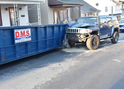 Three escape injury when Hummer crashes into dumpster on Race Street ...