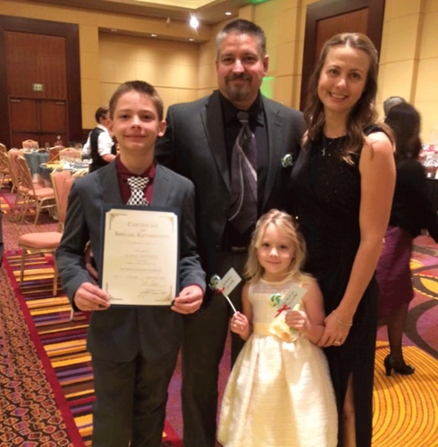 YAPS volunteer Austin Edwards, 11, receives a Student Leadership Award ...