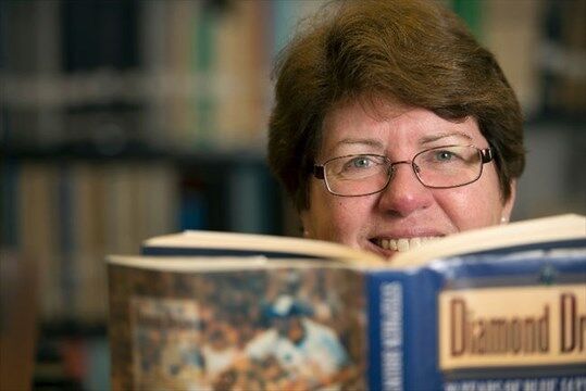 Longtime library head checking out