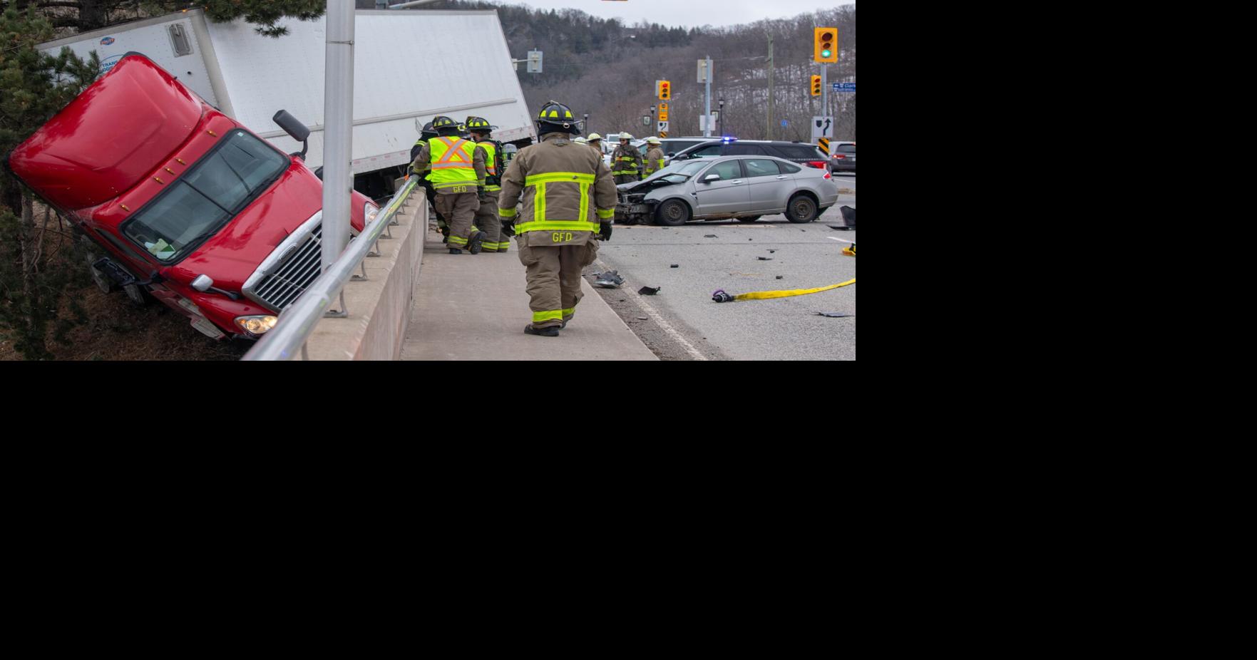 Transport truck hangs from QEW overpass after Grimsby crash