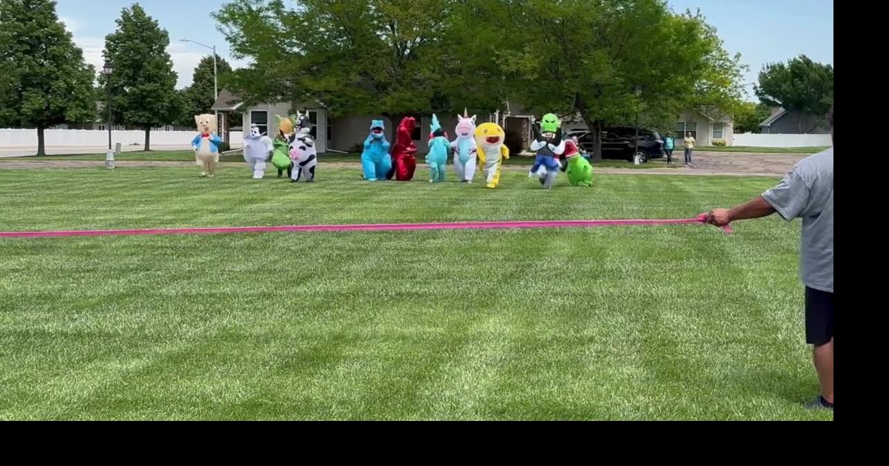 Linden Estates staff race wearing inflatable costumes