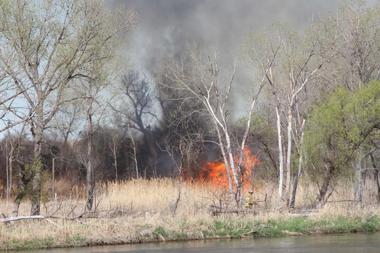 NP crews battle fire near river