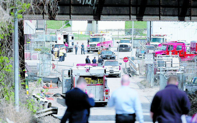 Rail car explosion flings one to ground, traps another