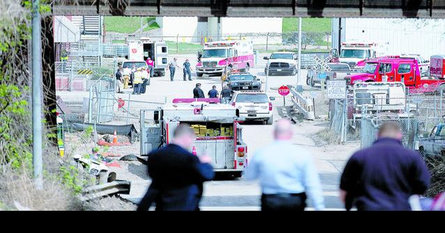 Rail car explosion flings one to ground, traps another