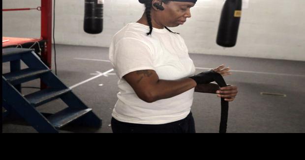 Renee Watts, left, of Crete, Ill., wraps her hands before Joe Orellana's