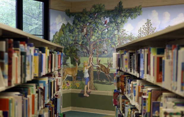 Michigan muralist spends two years painting at Lowell Public Library