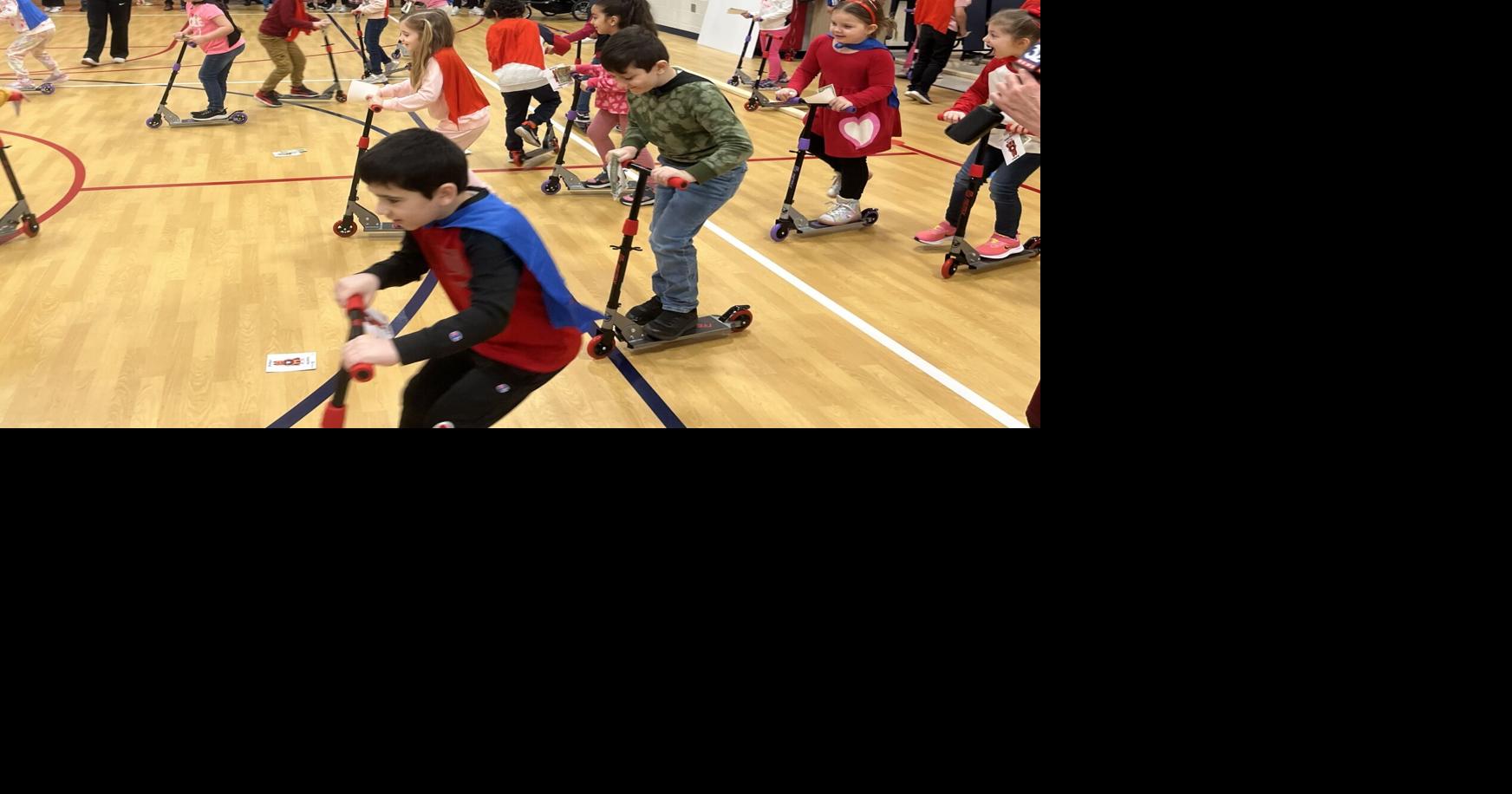 PHOTOS: Buddy's Helpers surprise Fernwood Elementary students with scooters
