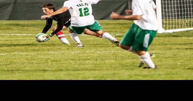Crown Point keeper Connor Keaveney grabs the ball before Valparaiso's ...