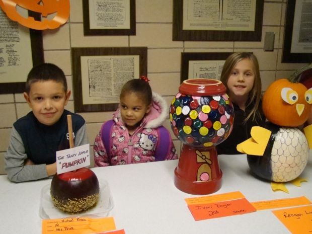 Students decorate pumpkins with their family for contest