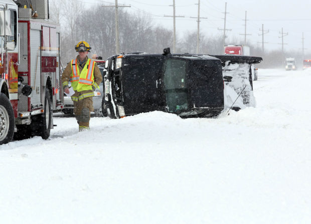 Police, plows working snow-covered, slick roads