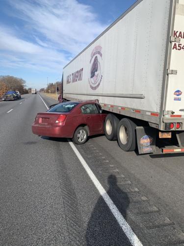 1 taken to hospital after car becomes lodged under semi, police say