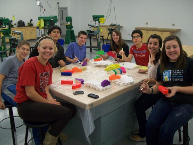 Eighth-graders craft wooden cars for needy children